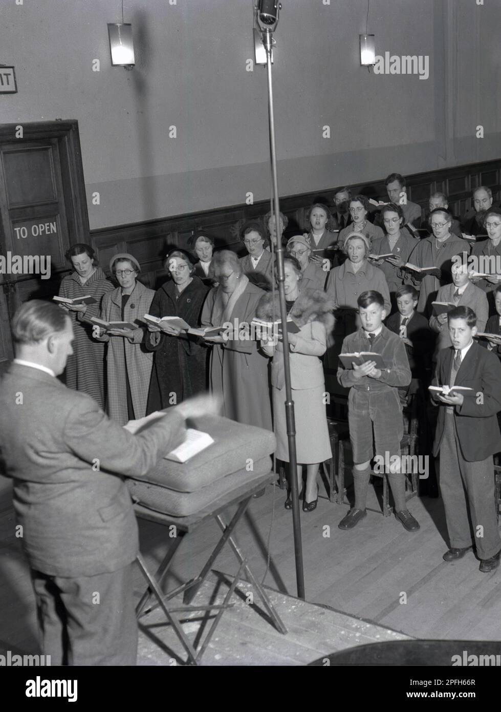 1940s, historical, well-dressed adults wearing coats, standing with ...