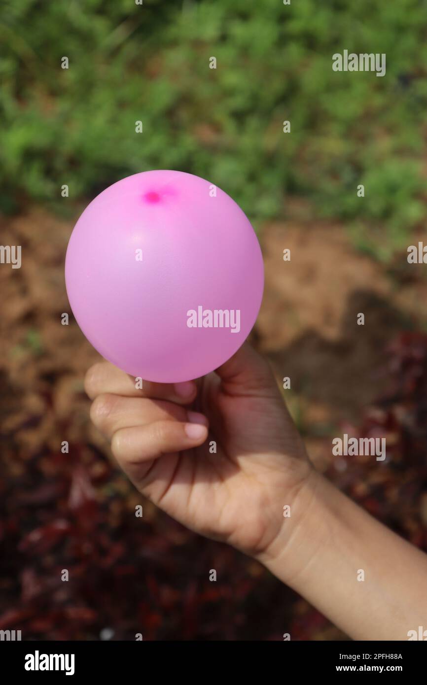 Pink balloon hand hi-res stock photography and images - Alamy