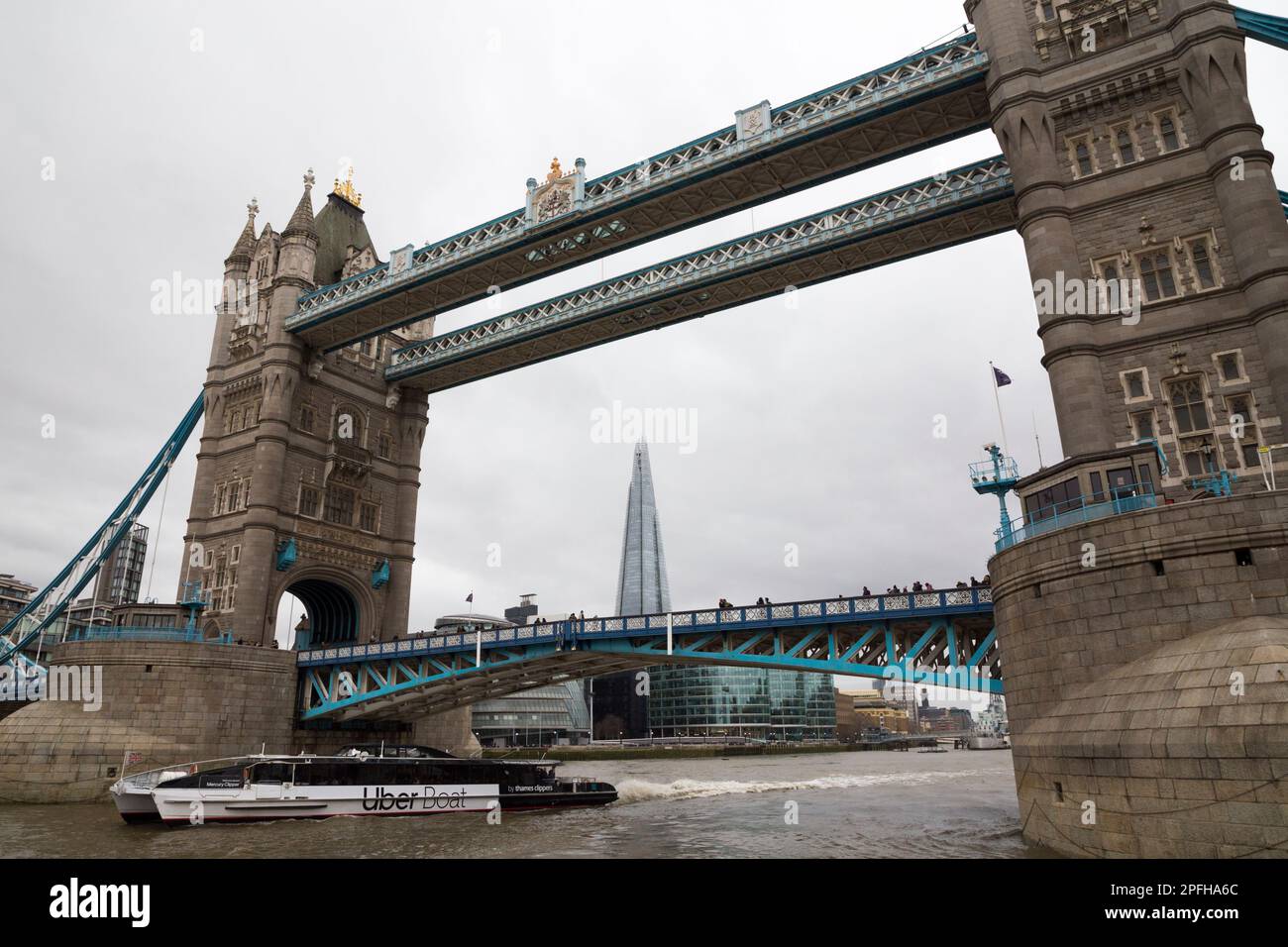 View of tourist tour boat and of Tower Bridge from water level boat ...