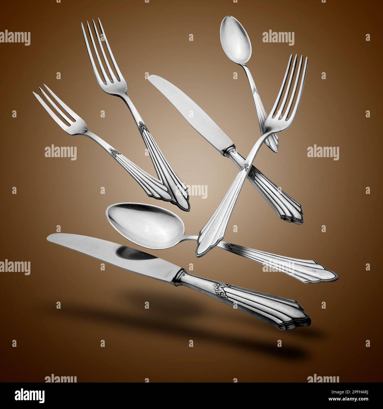 Floating Old Silverware Set with shadows on brown gradient background ...