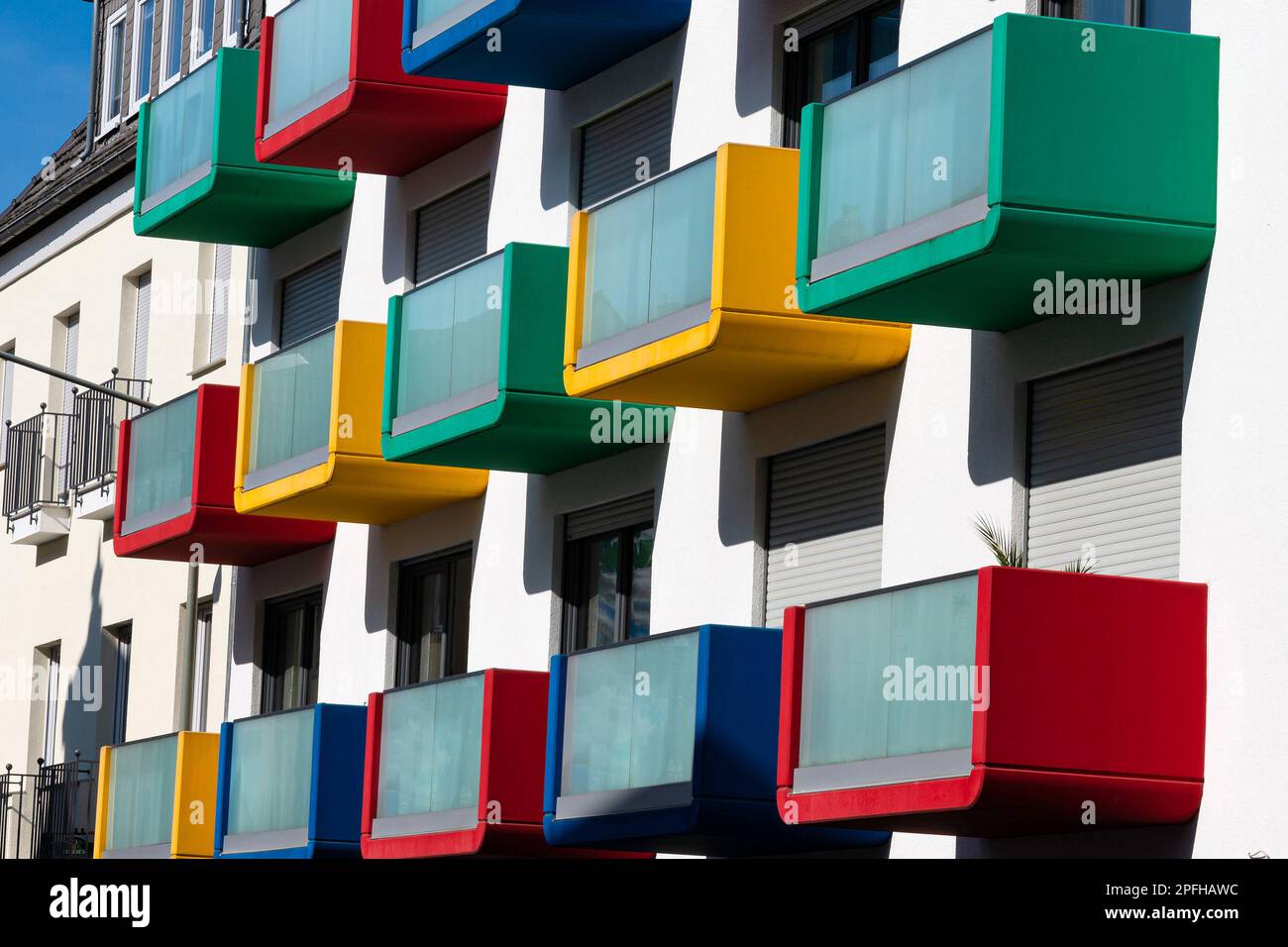 Facade of a residential building with multi colored vibrant balconies ...