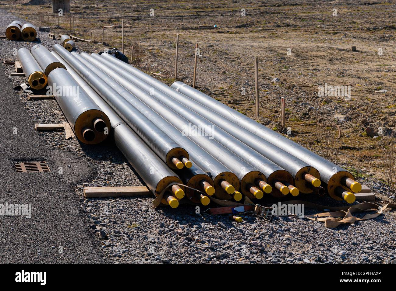 Stacked steel pipes with heat insulation at construction site Stock ...