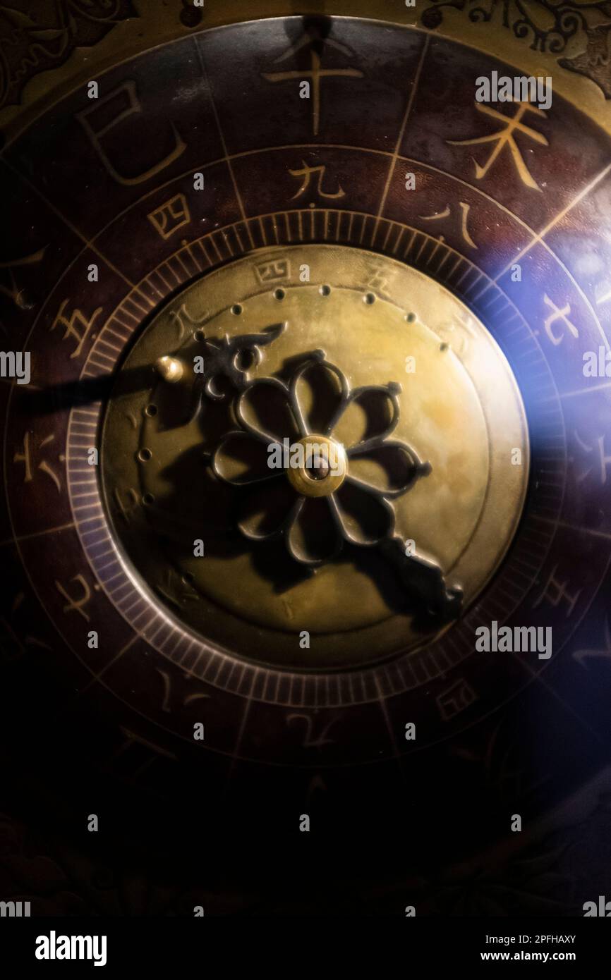 Ancient old clock watch with ancient asian and roman inscriptions close ...