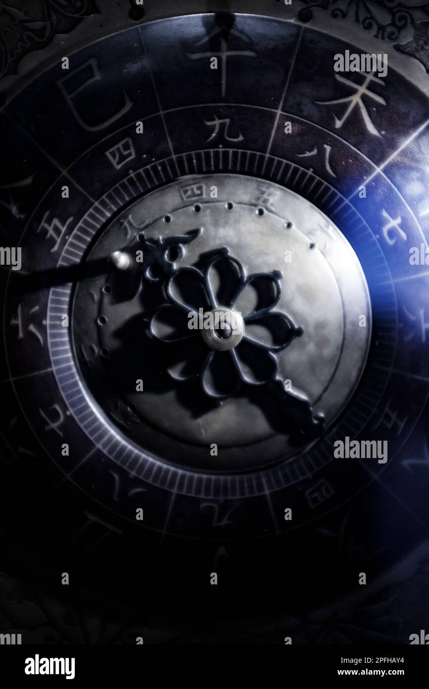 Ancient old clock watch with ancient asian and roman inscriptions close ...