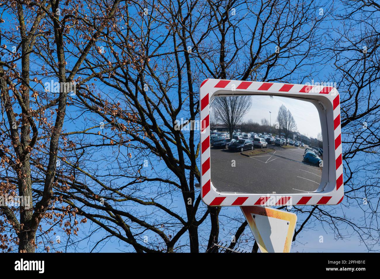 Street mirror in a large parking lot. Parked cars are displayed. Blue ...