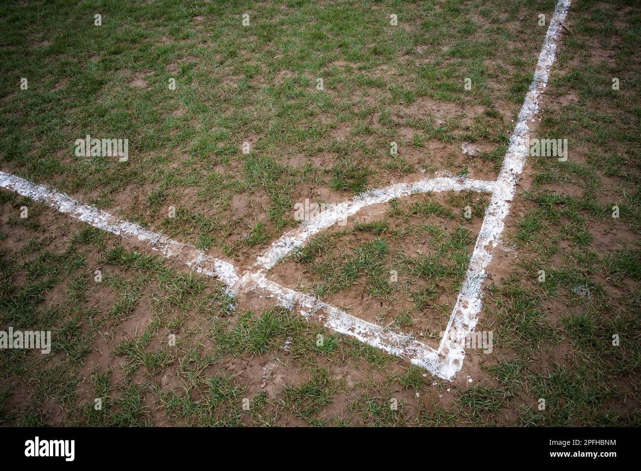 Corner markings on local muddy football pitch Stock Photo - Alamy