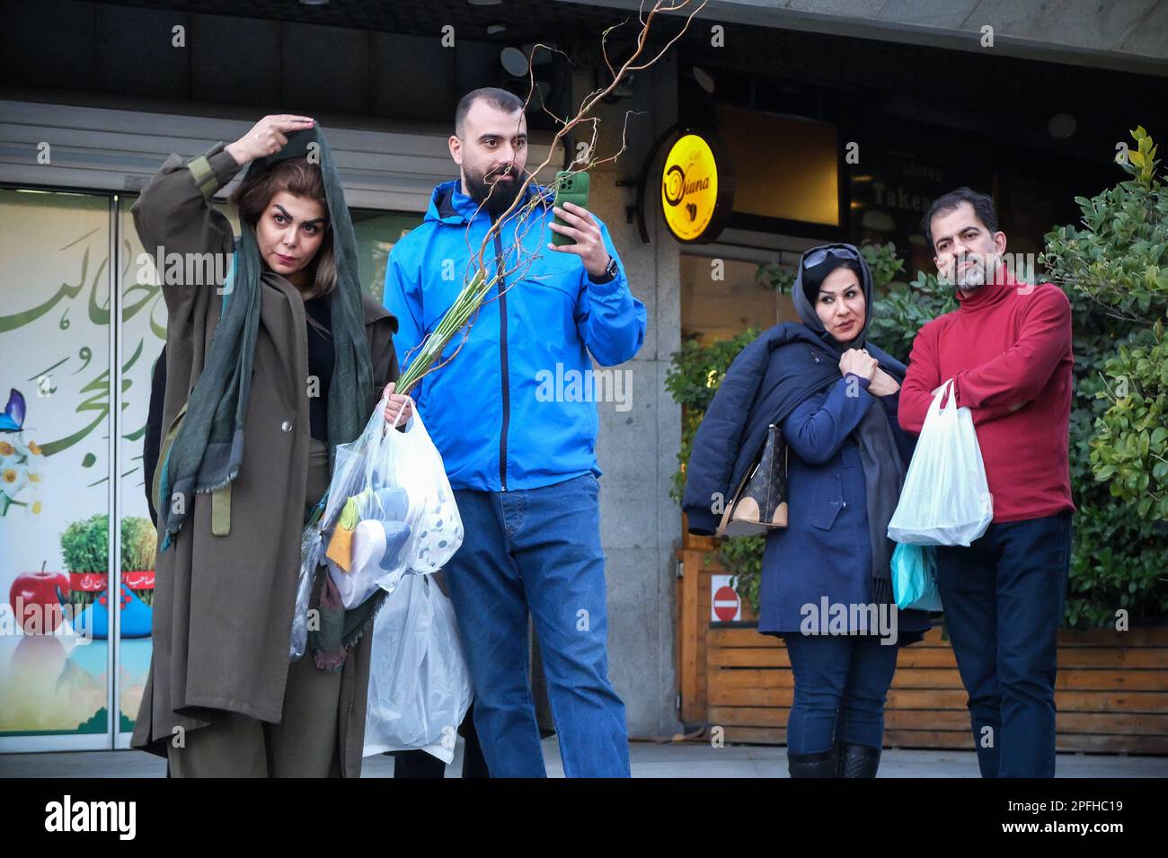 Tehran, Tehran, Iran. 16th Mar, 2023. People look at a street singer in ...