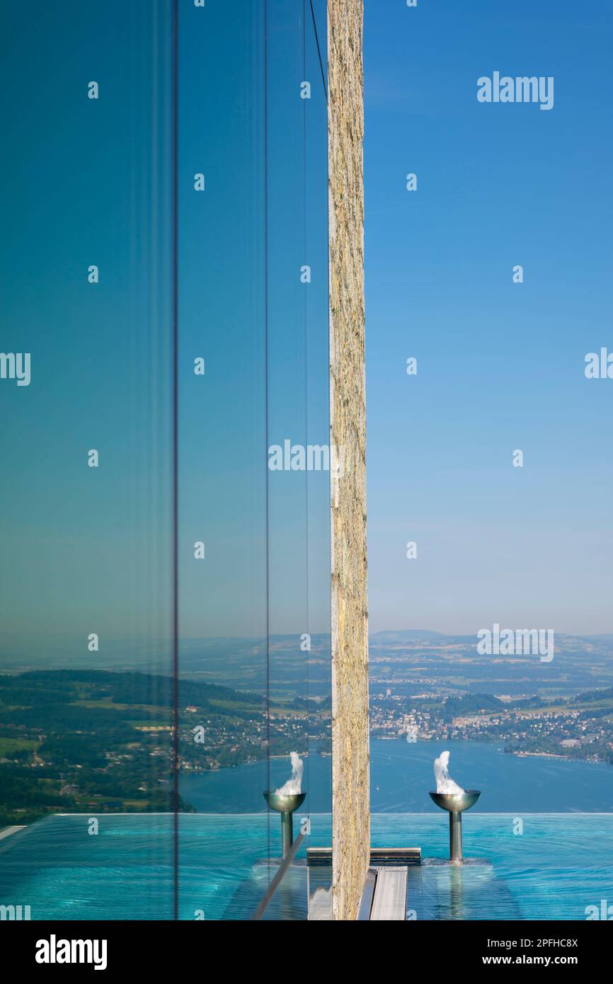 Infinity Swimming Pool with Reflection and View over Mountain and Lake ...