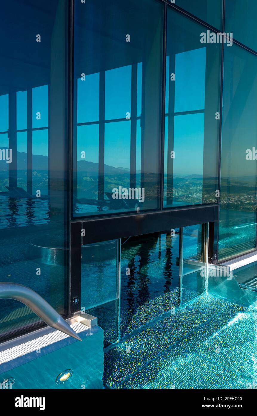 Infinity Swimming Pool with Reflection and View over Mountain and Lake ...