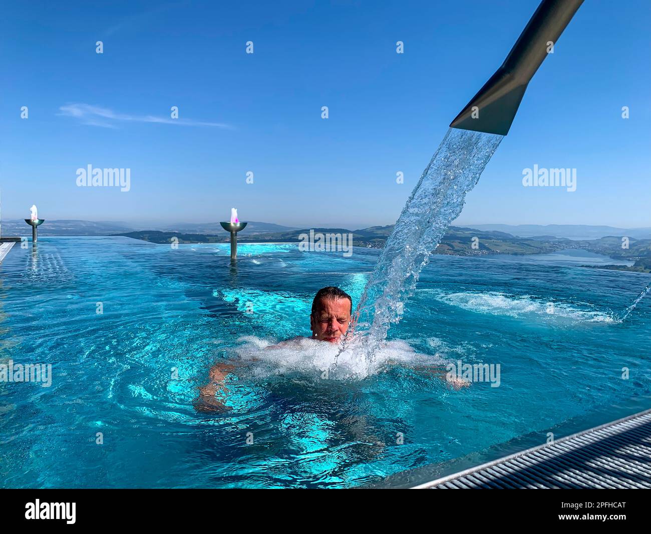 Man Enjoy Infinity Swimming Pool with Mountain and Lake Lucerne View in ...
