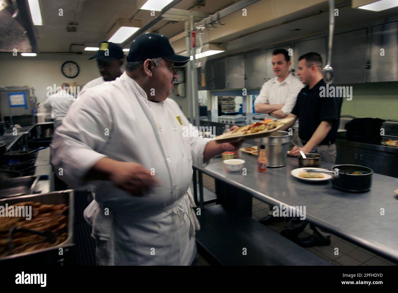 foodclass 109 ls.jpg Pablo hands out breakfast in the kitchen of the ...