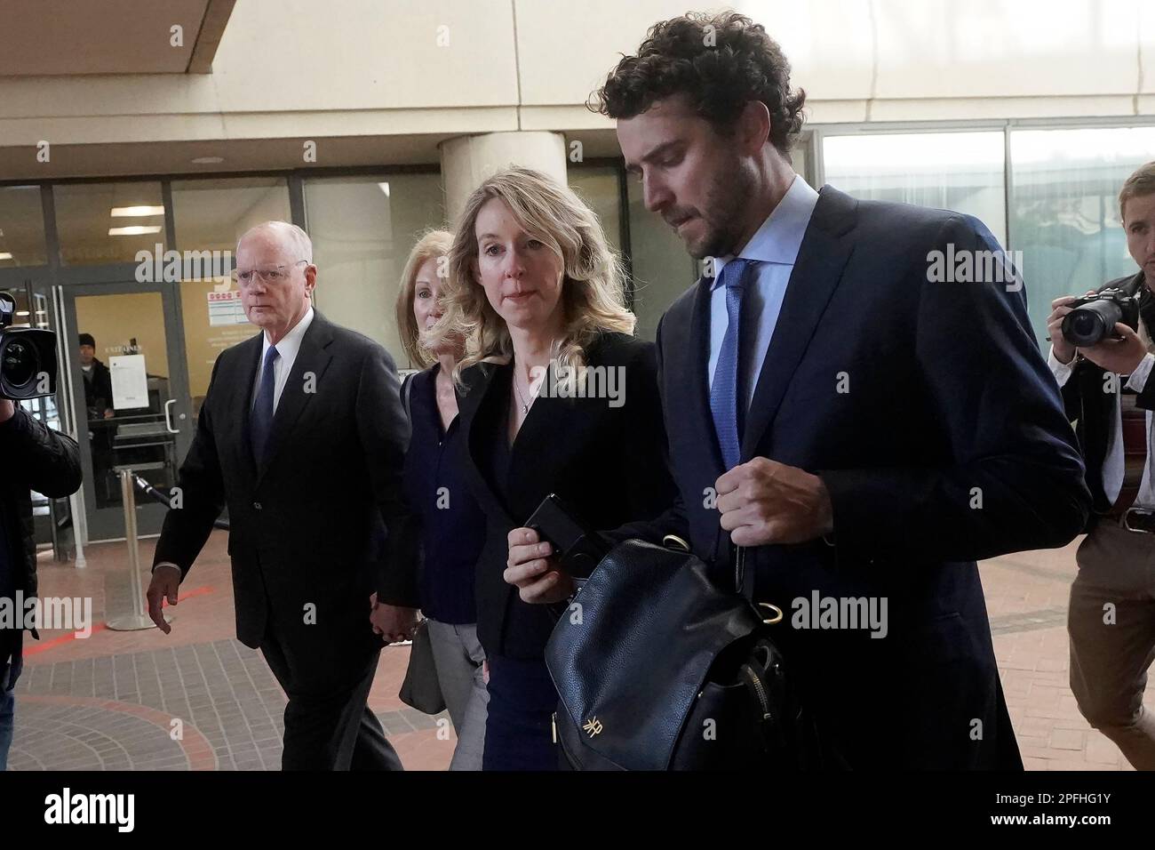 Former Theranos CEO Elizabeth Holmes, middle, arrives at federal court ...