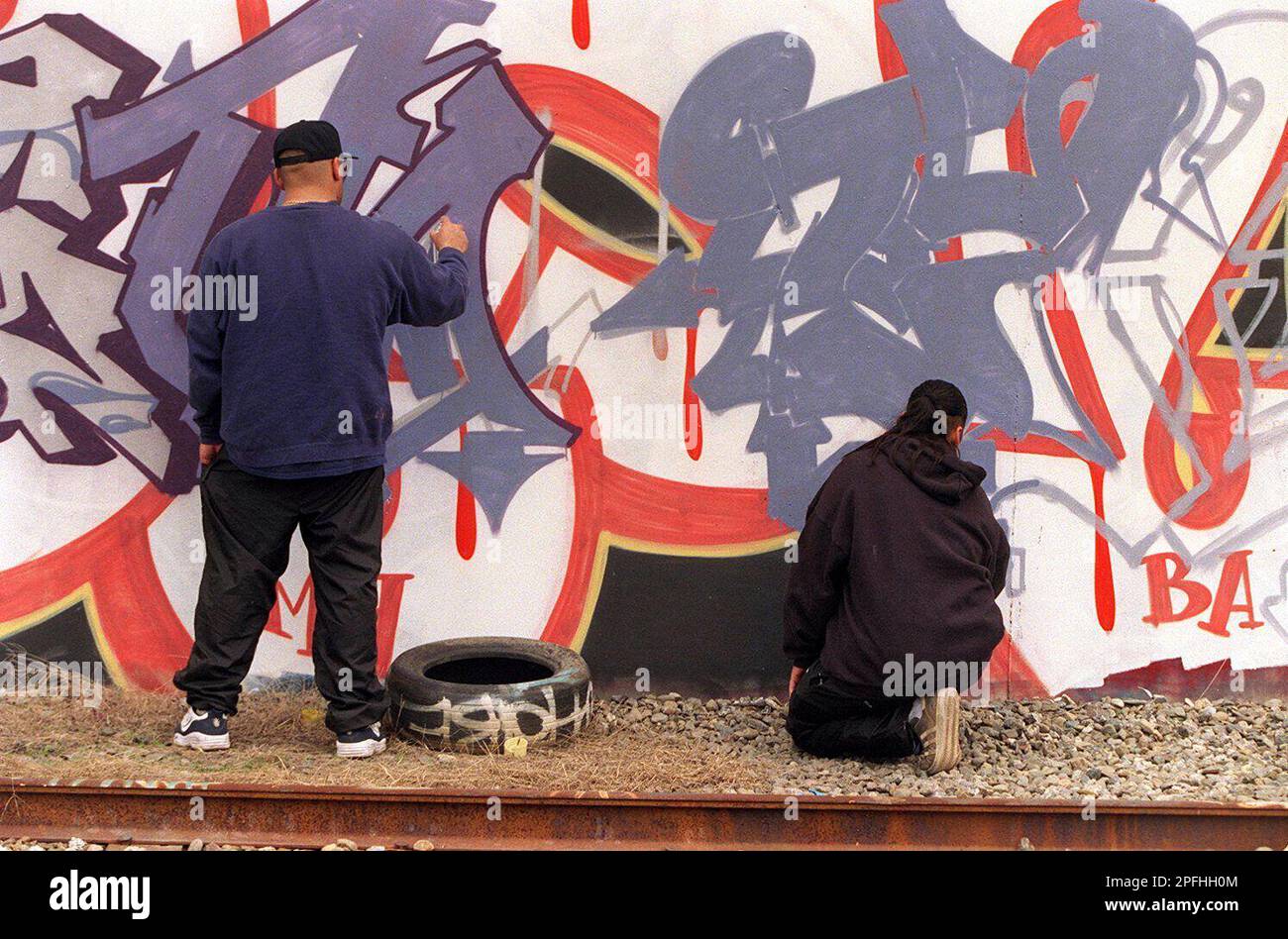 GRAFFITI 1a/C/09FEB97/CD/LS "Rob" and "Raza" work on a piece in Oakland ...