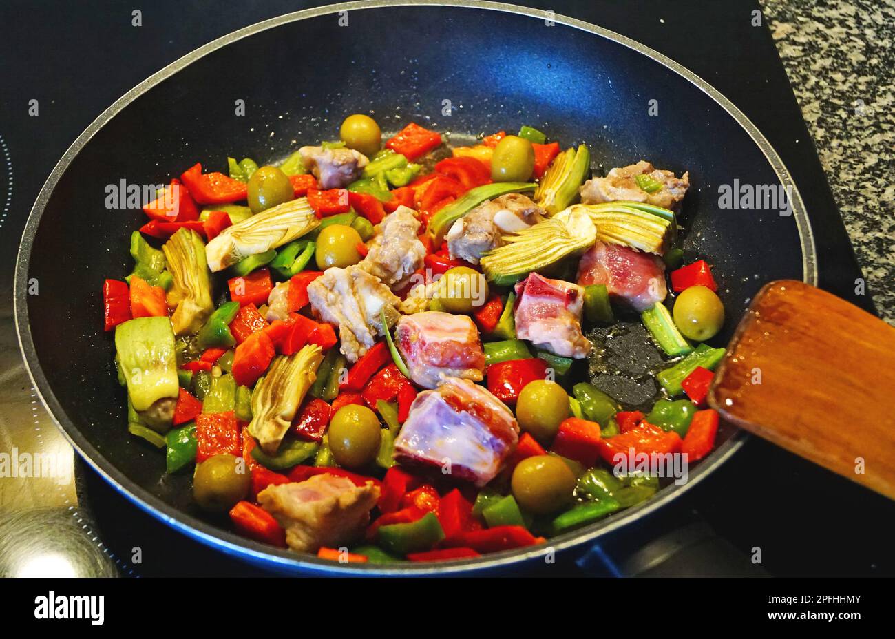 stir-fry for stew or paella over kitchen fire Stock Photo - Alamy