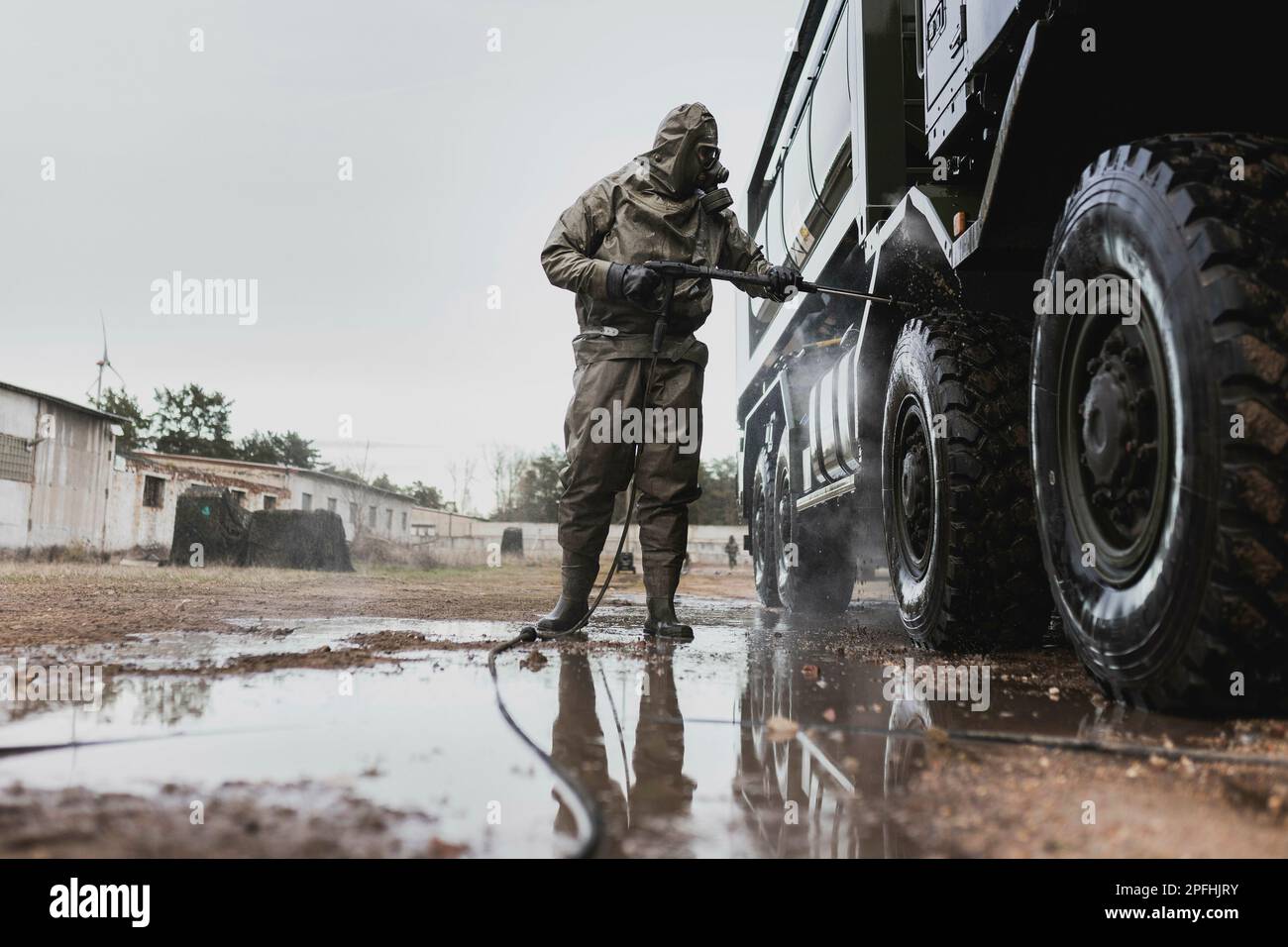 A NBC defense soldier in protective gear, pictured decontaminating a ...
