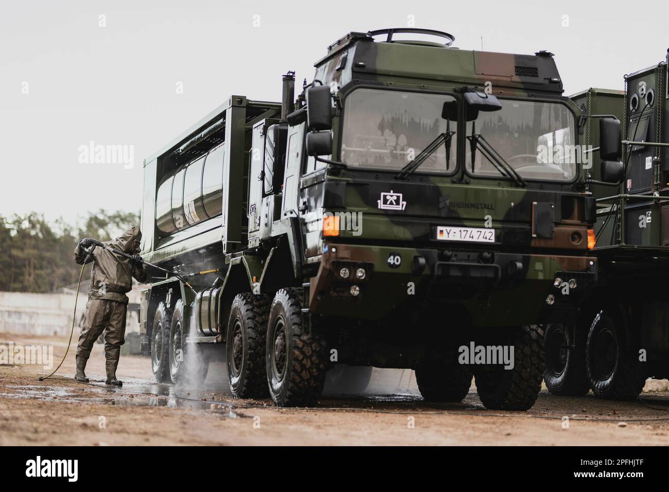 A NBC defense soldier in protective gear, pictured decontaminating a ...