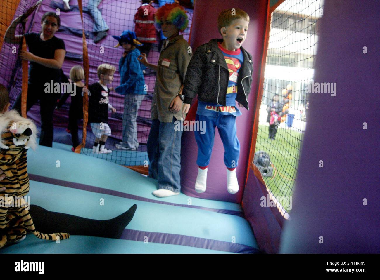 FETAL-26OCT02-LV-LS --- Sam Sieber, 6, plays in an inflatable jumper at ...