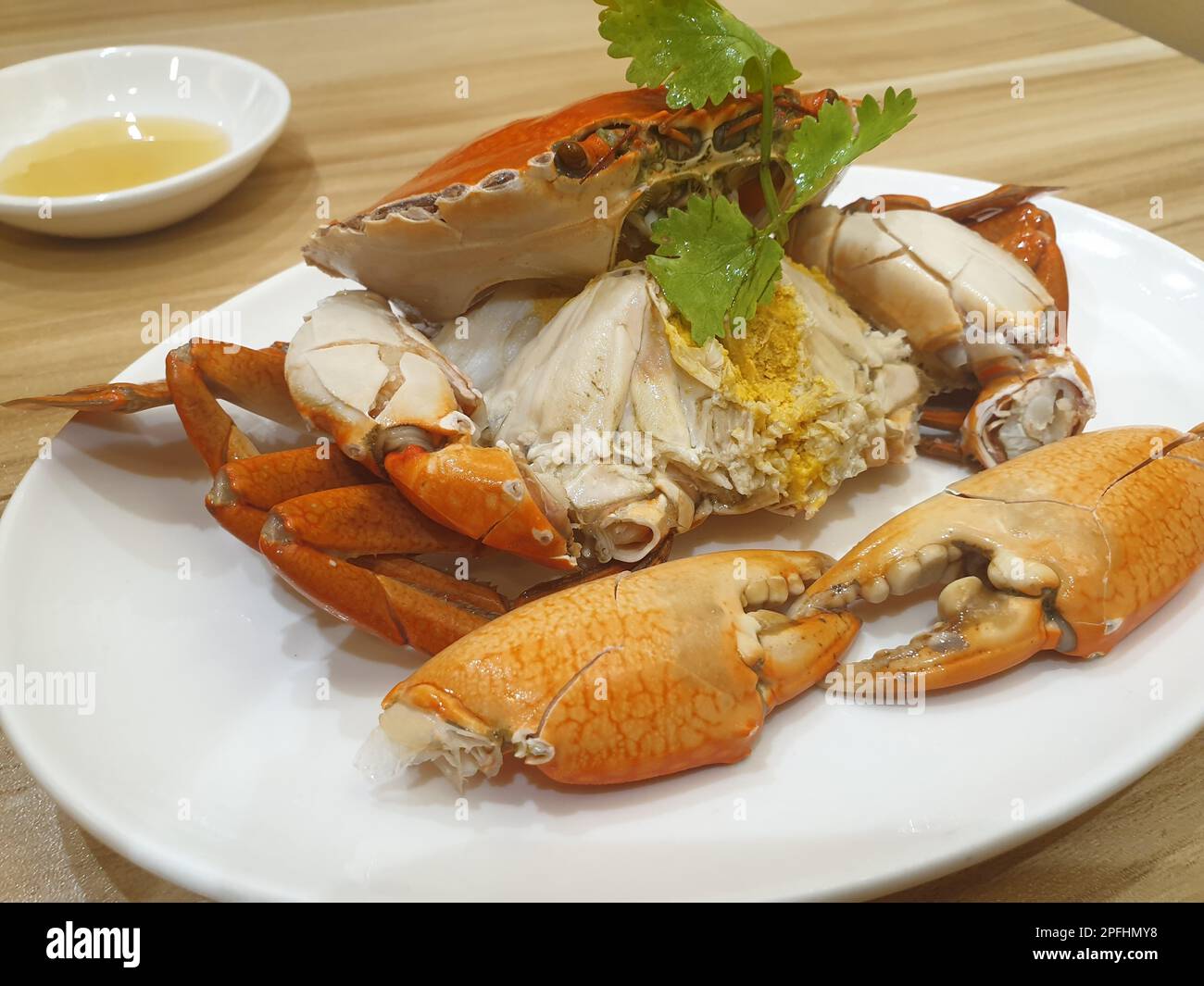 A plate of fresh seafood delicacies, featuring a selection of crab legs ...
