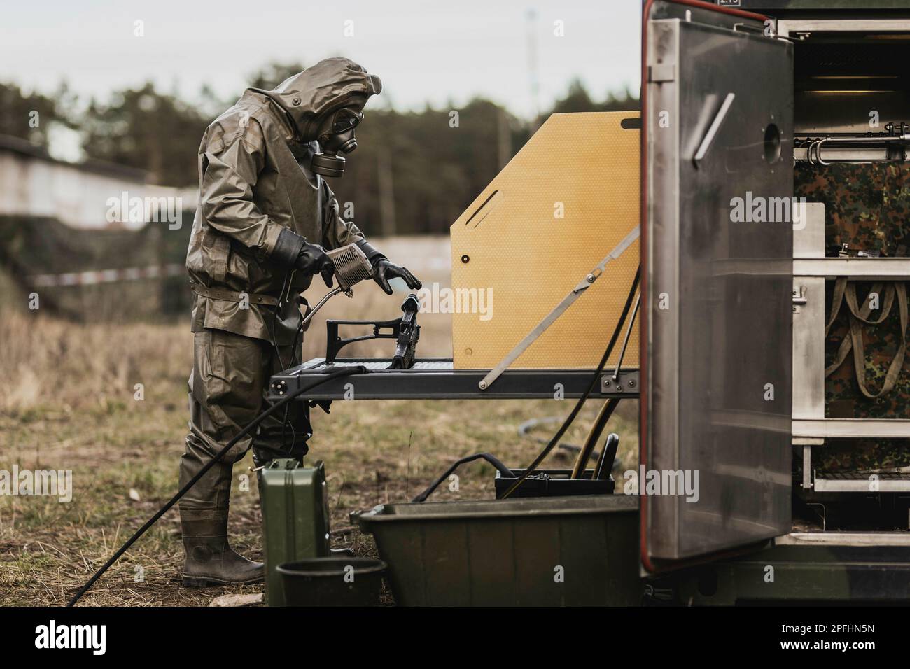 A NBC defense soldier in protective gear, pictured decontaminating ...