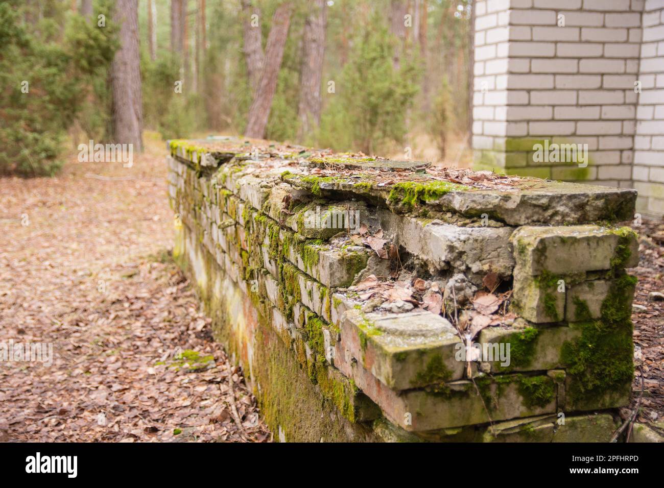 Destroyed brick wall at the entrance to the terrace of an abandoned and ...