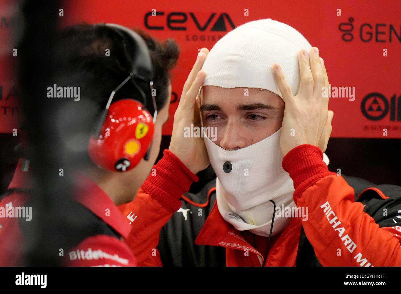Ferrari driver Charles Leclerc of Monaco fixes his balaclava at pits ...