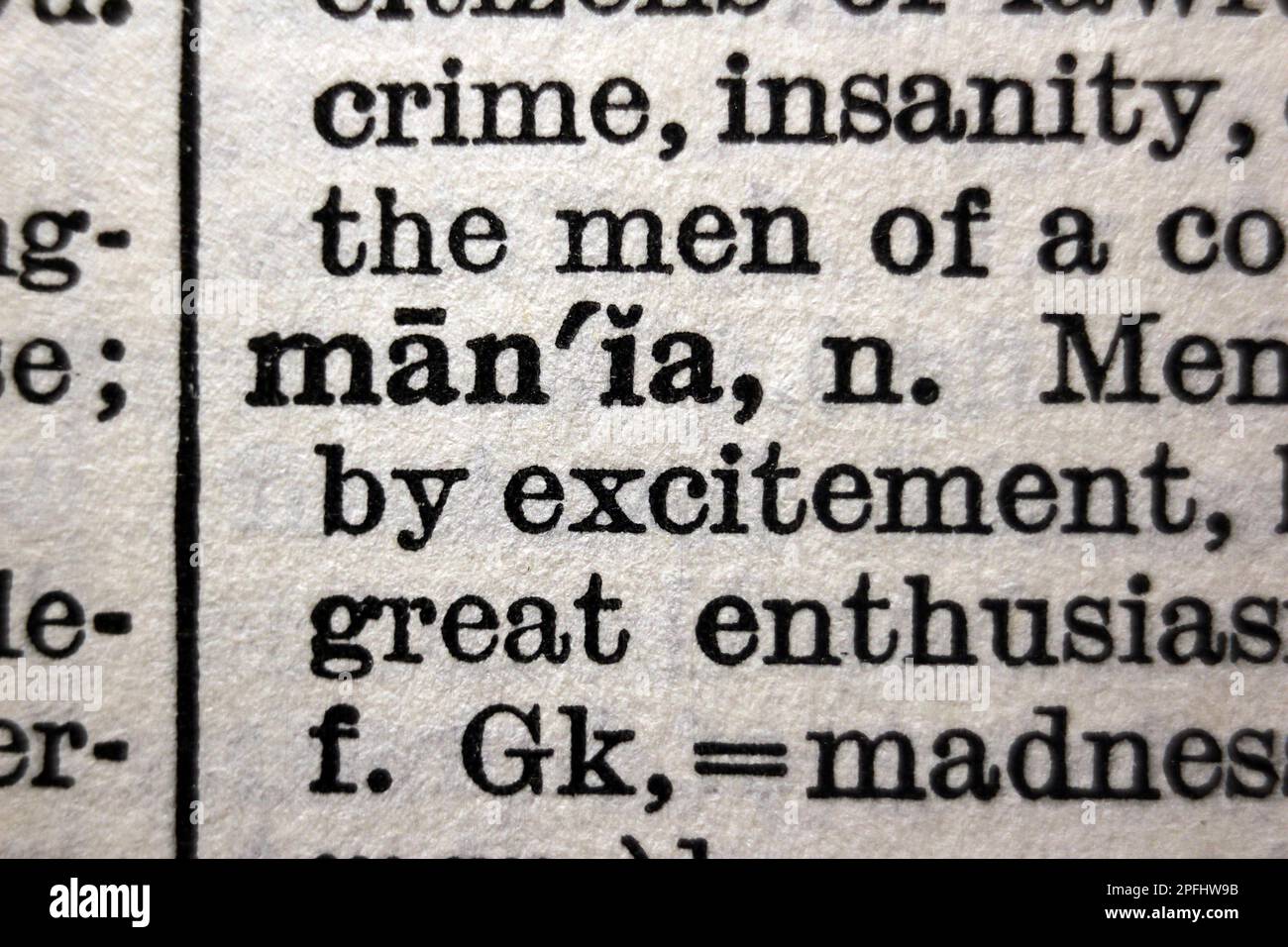 Definition of word mania on dictionary page, close-up Stock Photo - Alamy
