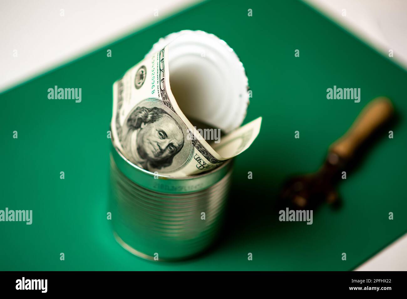 Dollars in an open tin can and a snippet. Safeguarding cash, stash ...