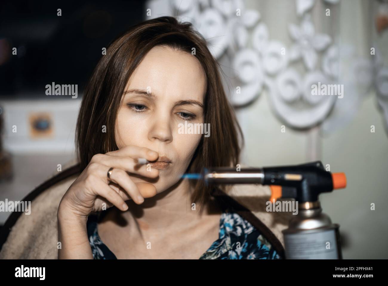 Woman lights a cigarette hi-res stock photography and images - Alamy
