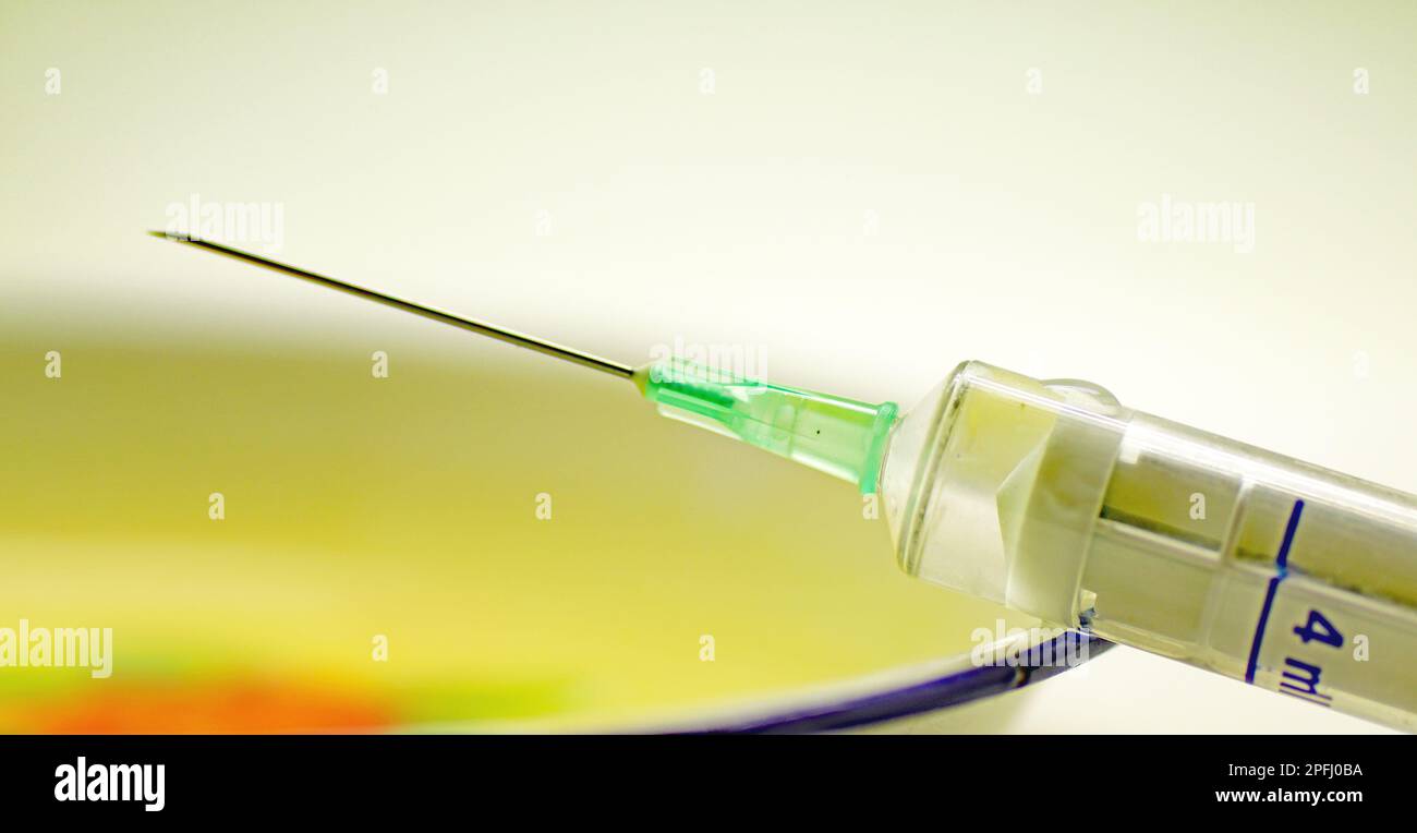 Syringe and needle on white background with drops of water Stock Photo ...