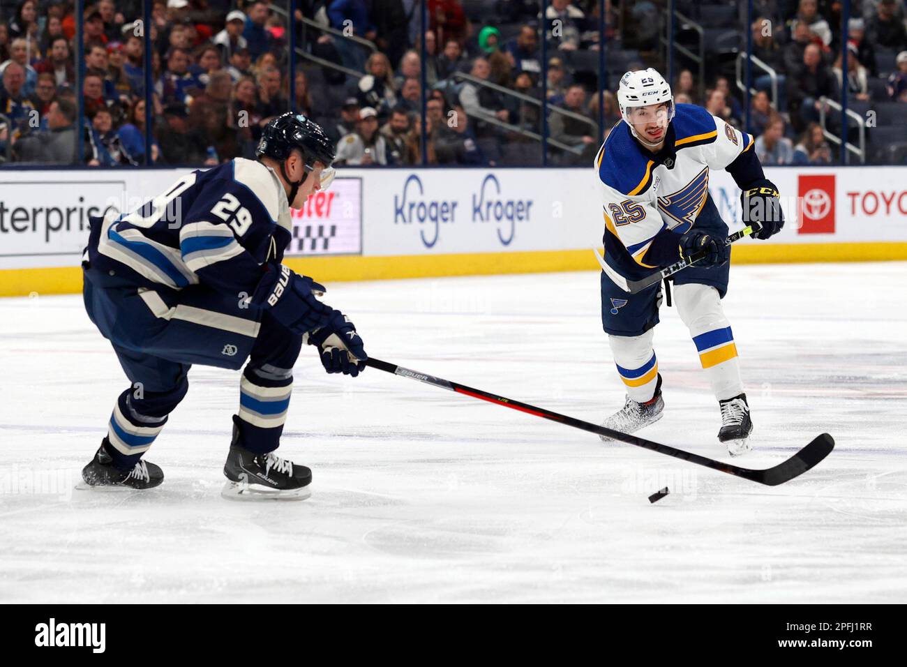 St. Louis Blues forward Jordan Kyrou, right, passes the puck in front ...