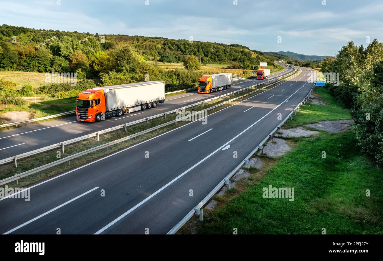 Convoy of Trucks with containers on highway, cargo transportation ...