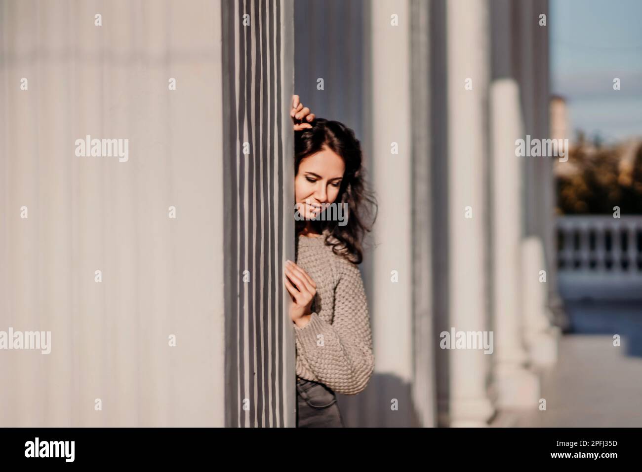 Woman building columns. An athletic woman in her 40s, dressed in a ...