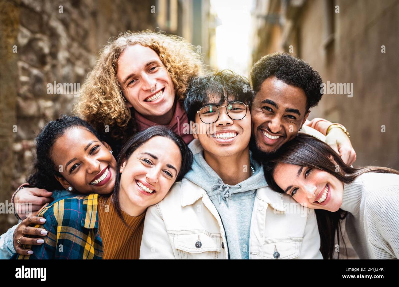 Multi racial guys and girls taking selfie outdoors with backlight - Happy life style friendship ...