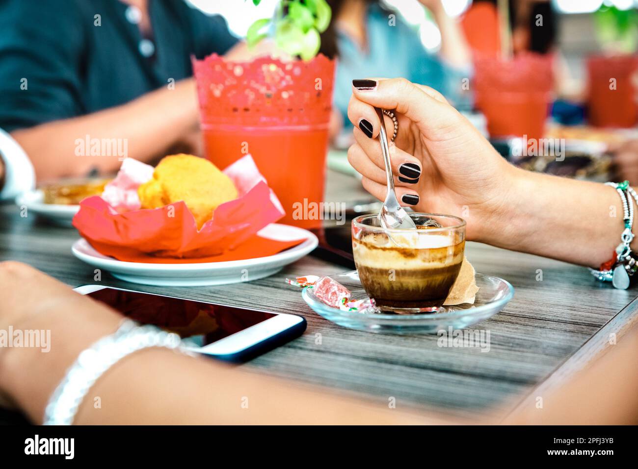 Close up of friends drinking coffee in glass at bar cafeteria ...