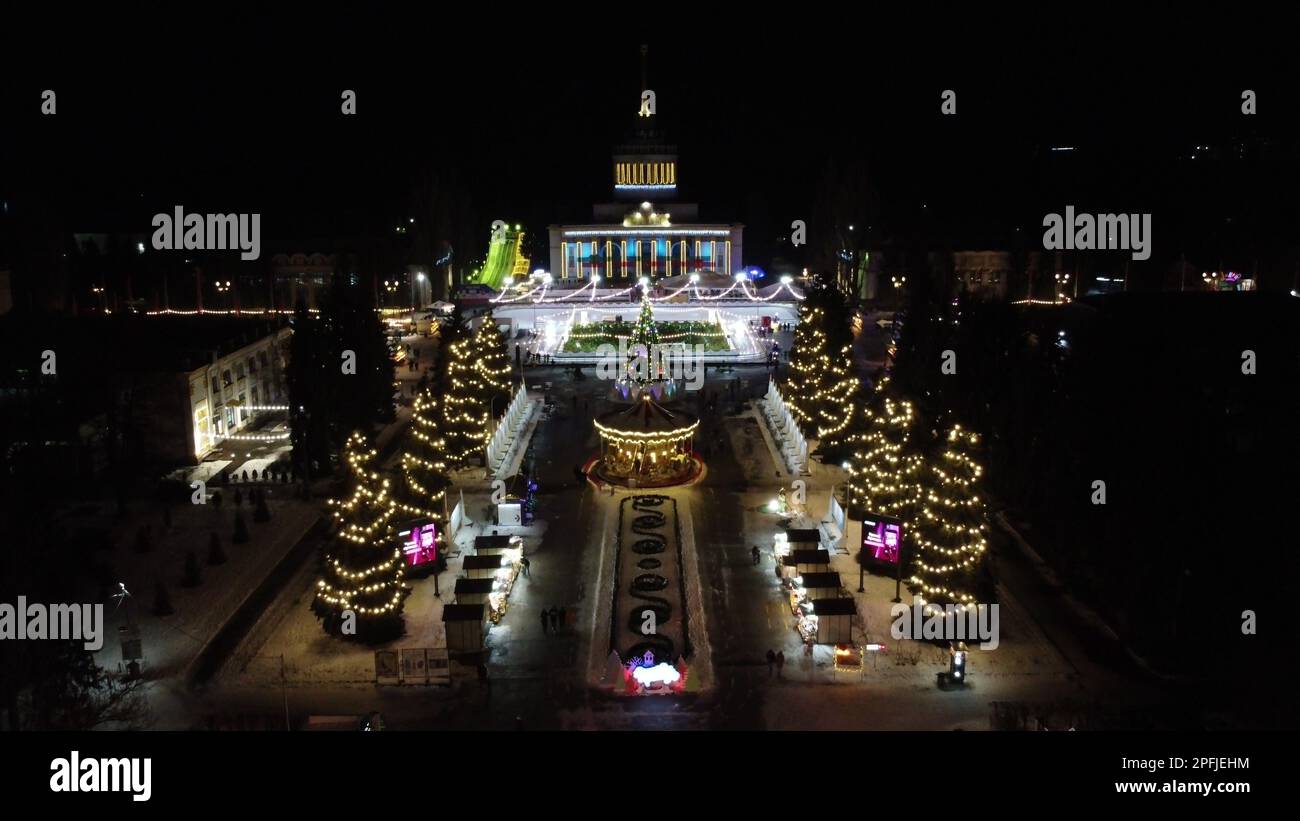 Landscape view large building, Christmas trees, children's spinning ...