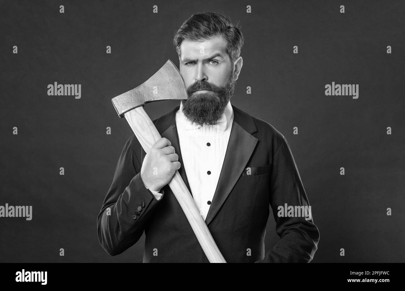 Portrait of serious brutal man holding axe at bearded face dark ...