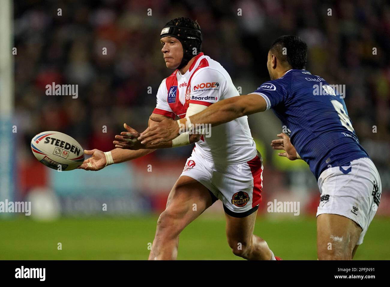 St Helens’ Jonny Lomax (left) passes before being tackled by Hull FC’s ... St Helens’ Jonny Lomax (left) passes before being tackled by Hull FC’s ...