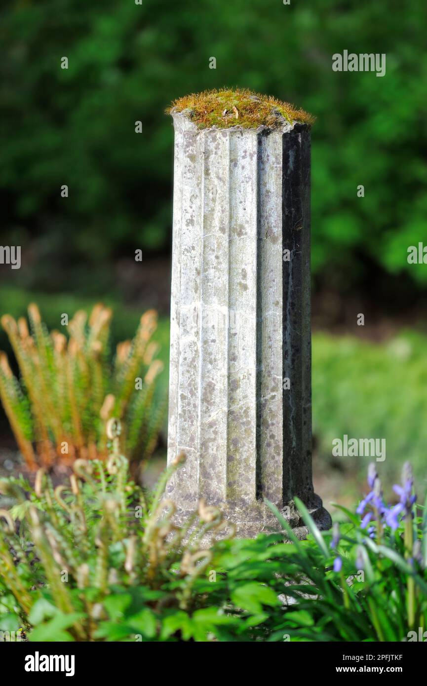 A cement column is used as an architectural element in this garden at ...