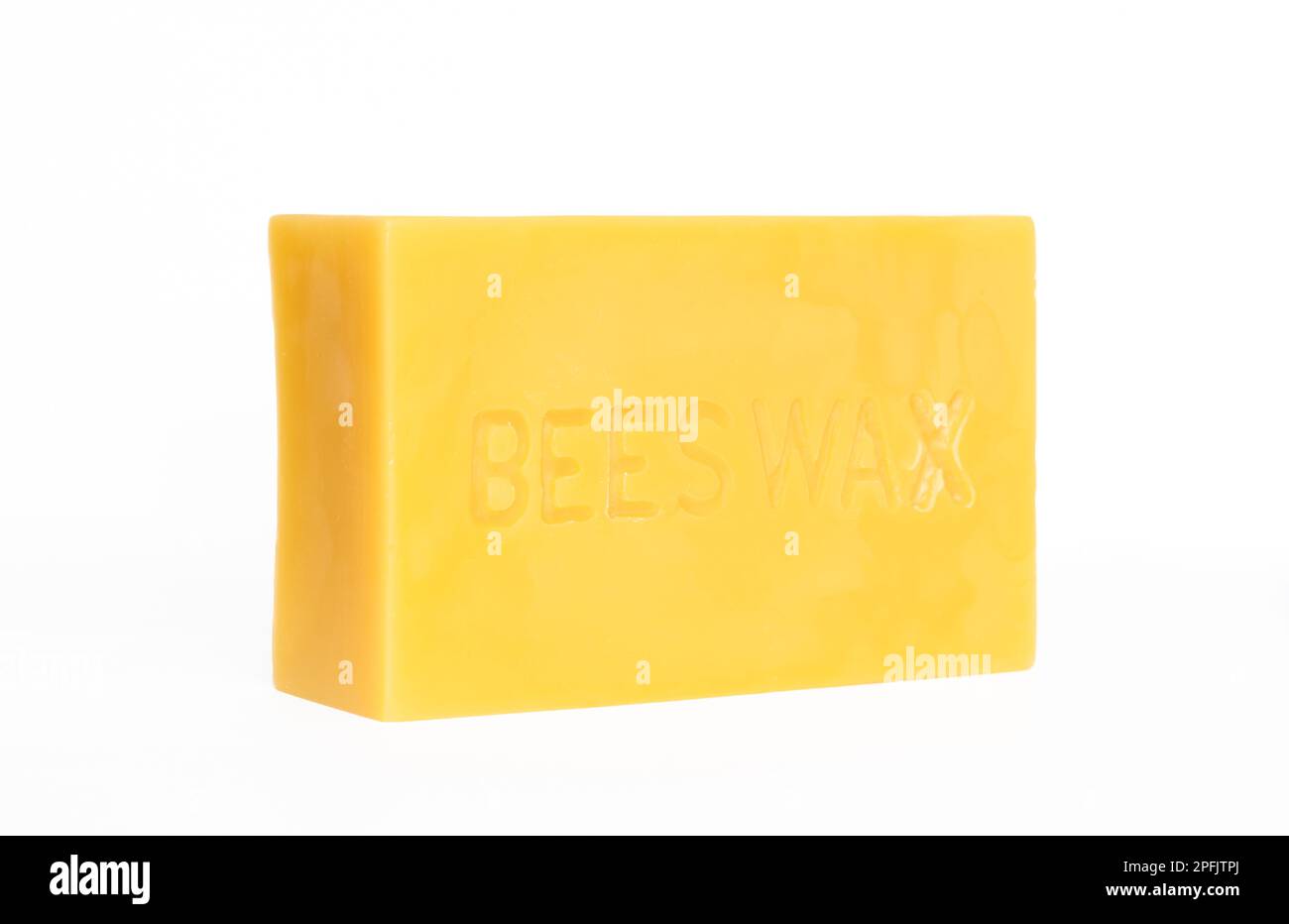 An angled view of a brick of pure beeswax on a white background Stock ...