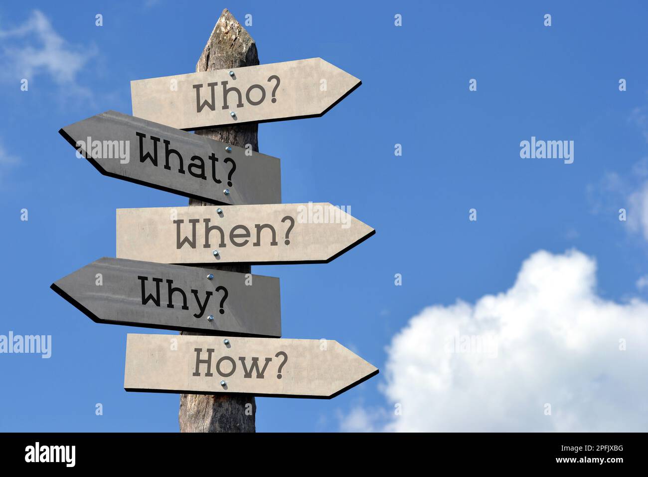 Who, what, when, why, how - wooden signpost with five arrows, sky with ...