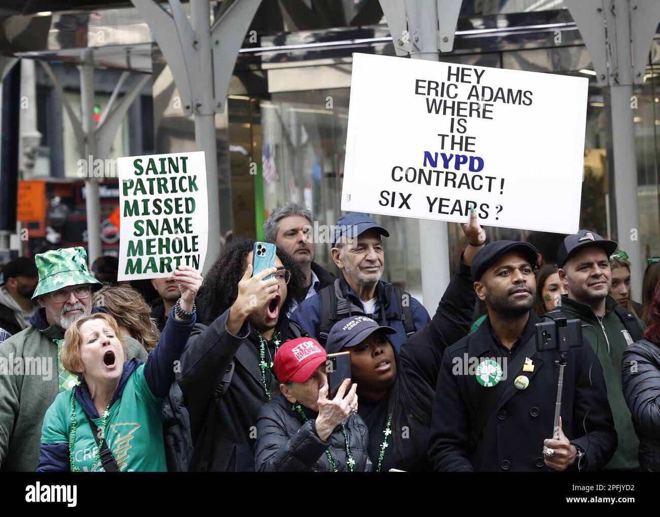 New York, United States. 17th Mar, 2023. Parade attendees hold up signs ...
