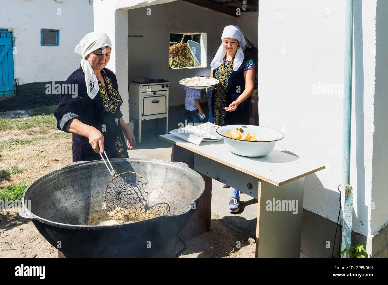Kazakh woman preparing traditional local tandyr bread, Shymkent ...