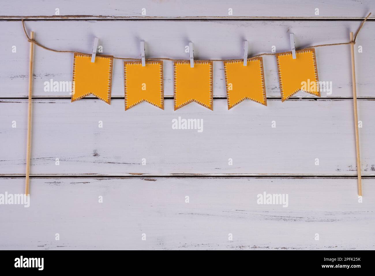 clothesline with party flags on white wooden table Stock Photo - Alamy