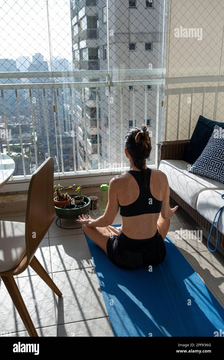 Brazilian woman, 42 years old, sitting in a yoga position, meditating ...