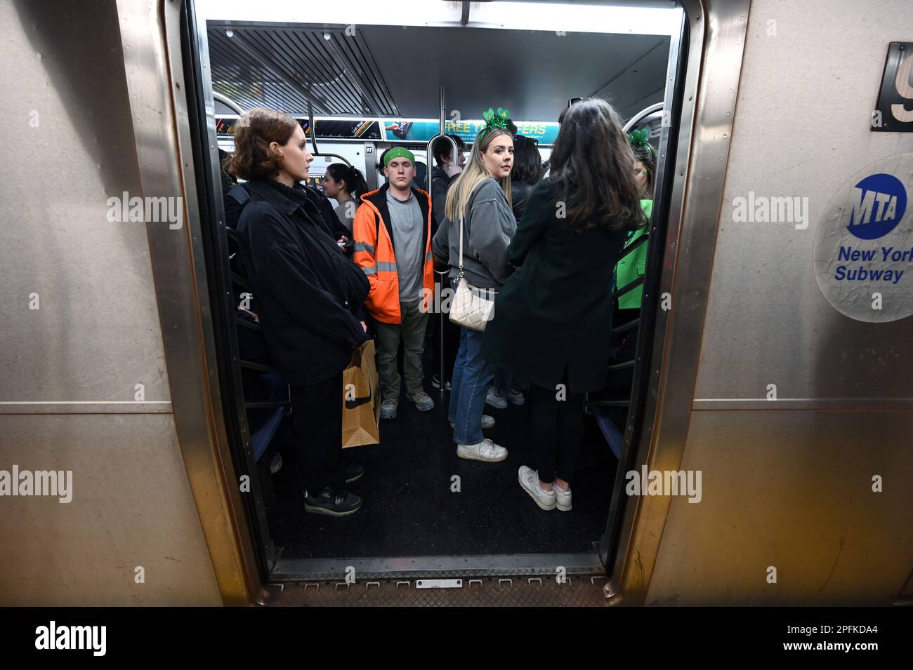 New York, USA. 17th Mar, 2023. A woman wears a clover head band while ...