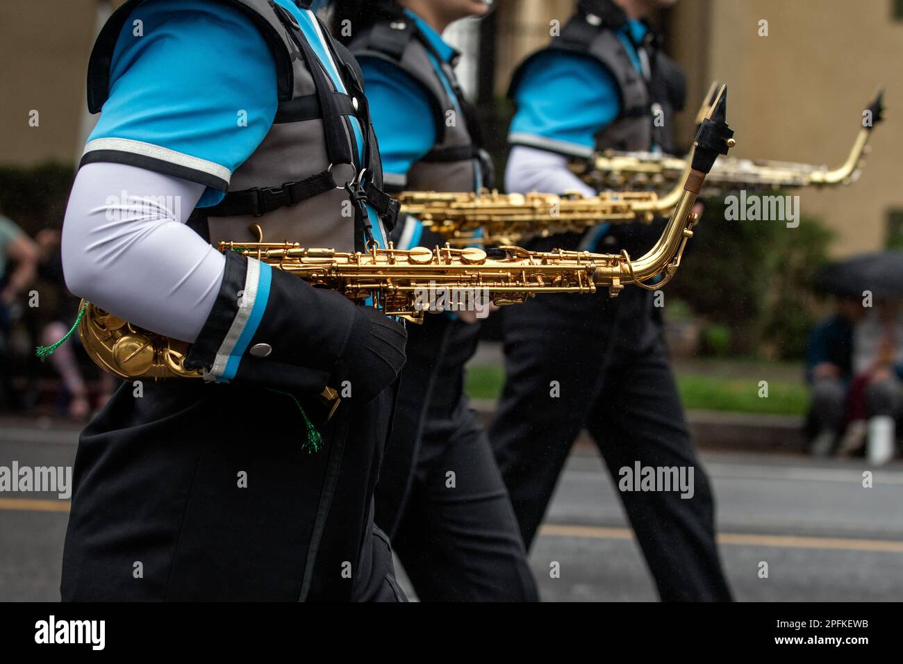 Gloved hands of saxophone players of marching band holding brass ...
