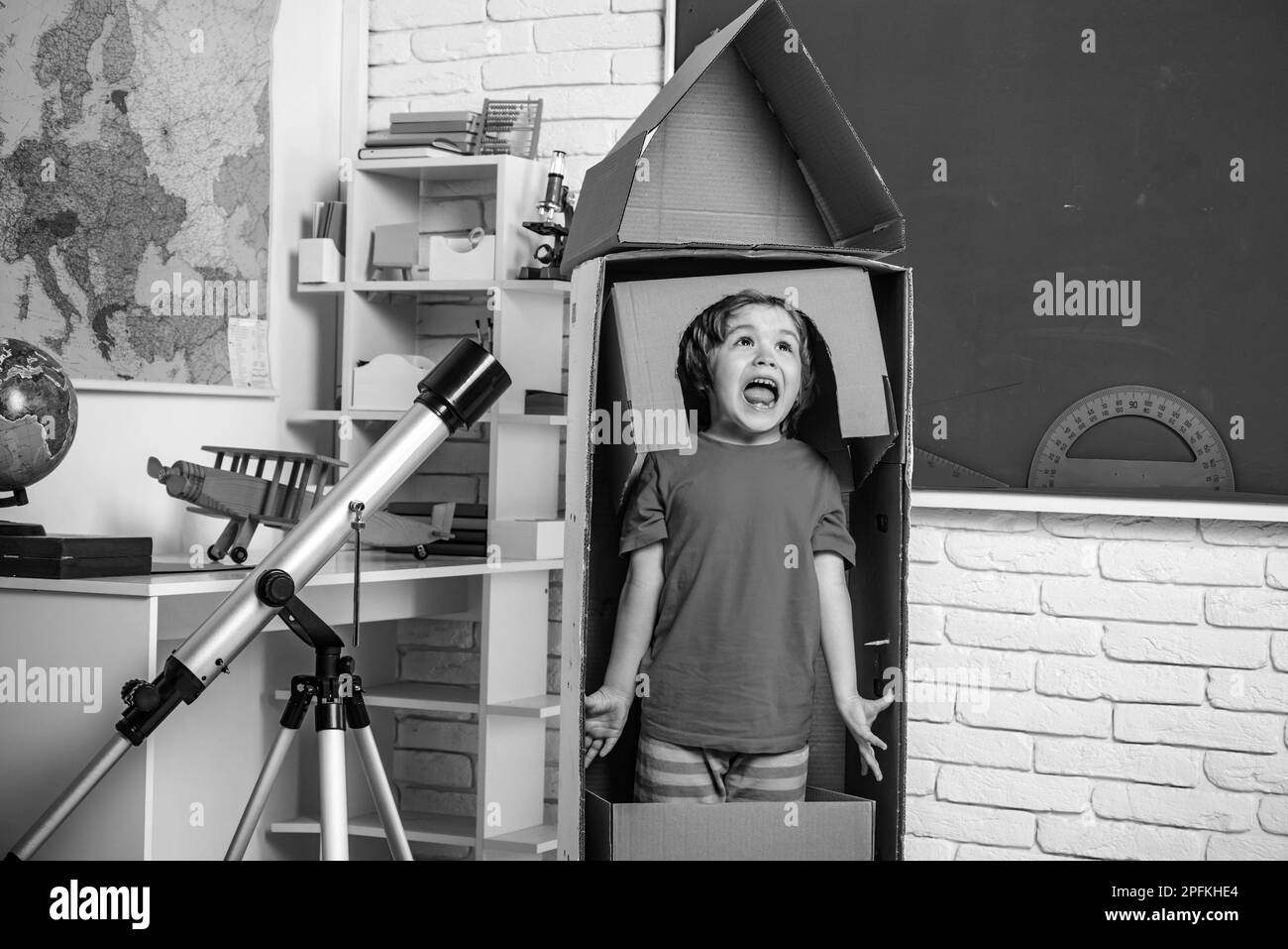 Happy child playing with toy rocket. Childhood Dreams. Spaceship flight ...