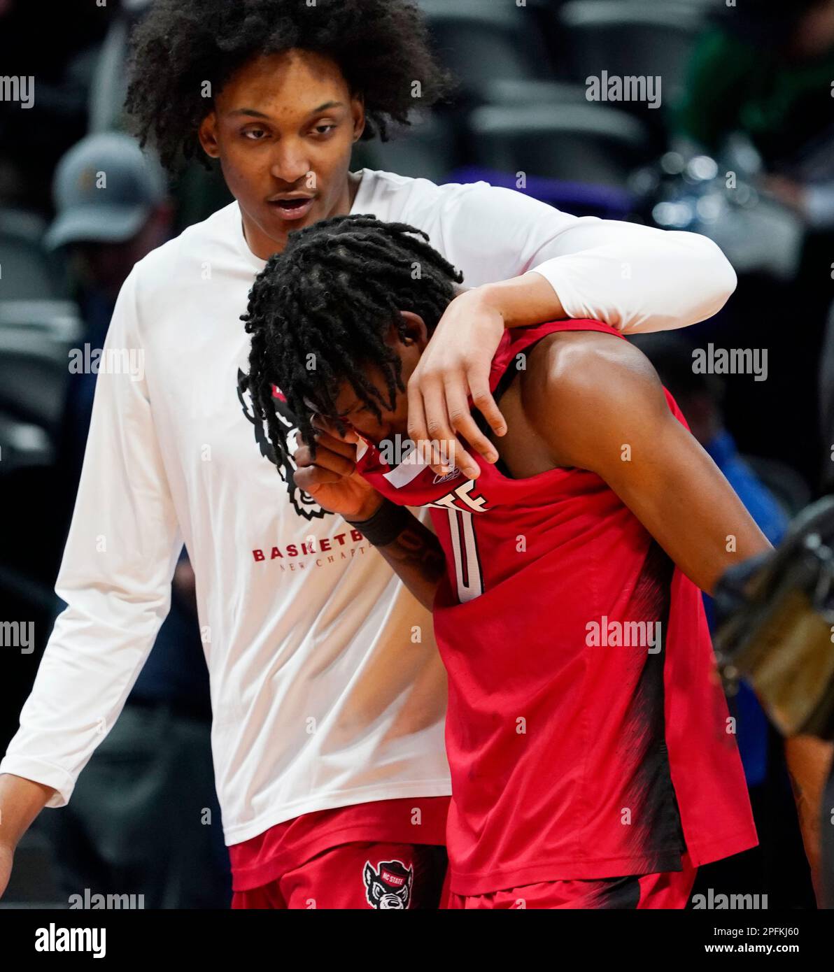North Carolina State guard Terquavion Smith, front, is comforted as he ...