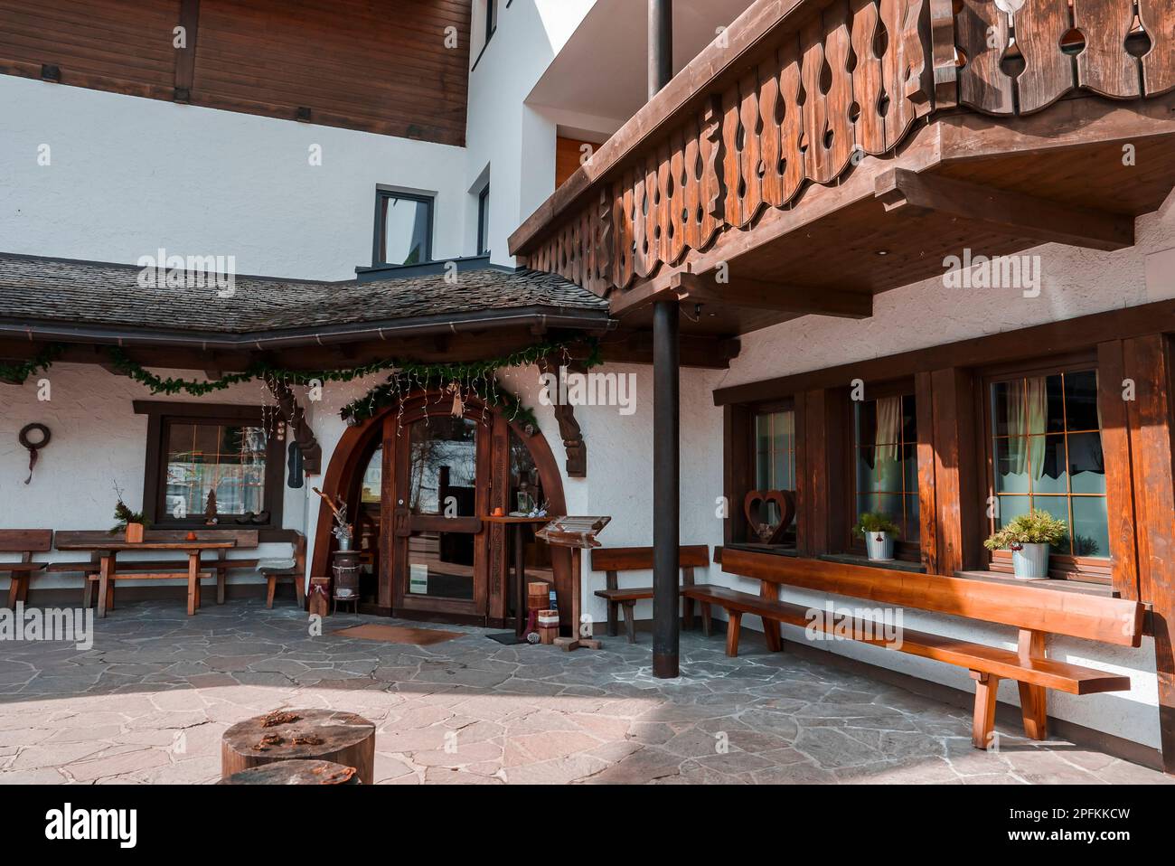 Hotel building with wooden benches and seats at entrance Stock Photo ...