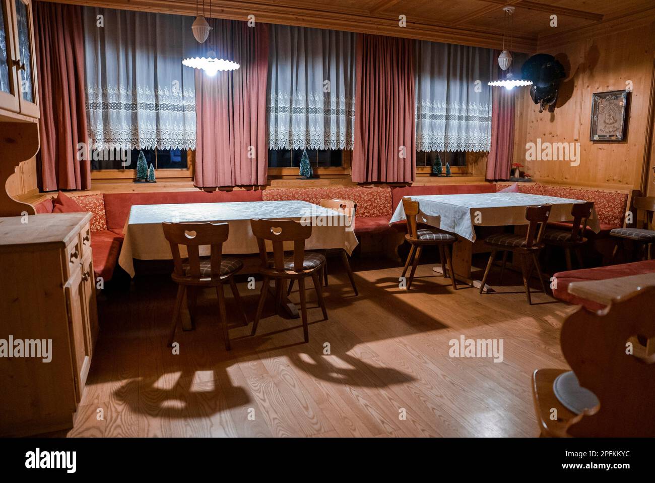 Illuminated pendant lights over chairs and tables in hotel Stock Photo ...